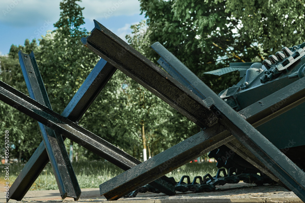 Anti-tank hedgehogs and tank closeup and peaceful background. Monument ...