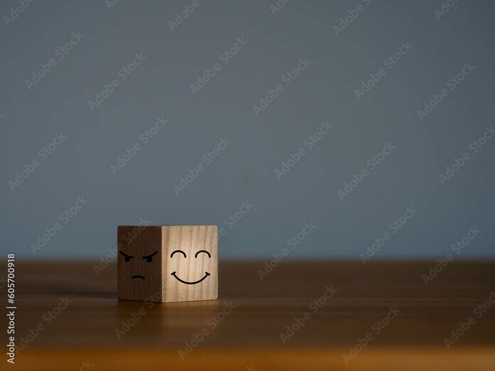 Smiling faces and sad faces in the dark on a wooden cube Emotional ...