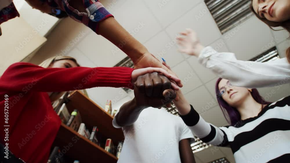 Group of international students supporting each other on stood around ...