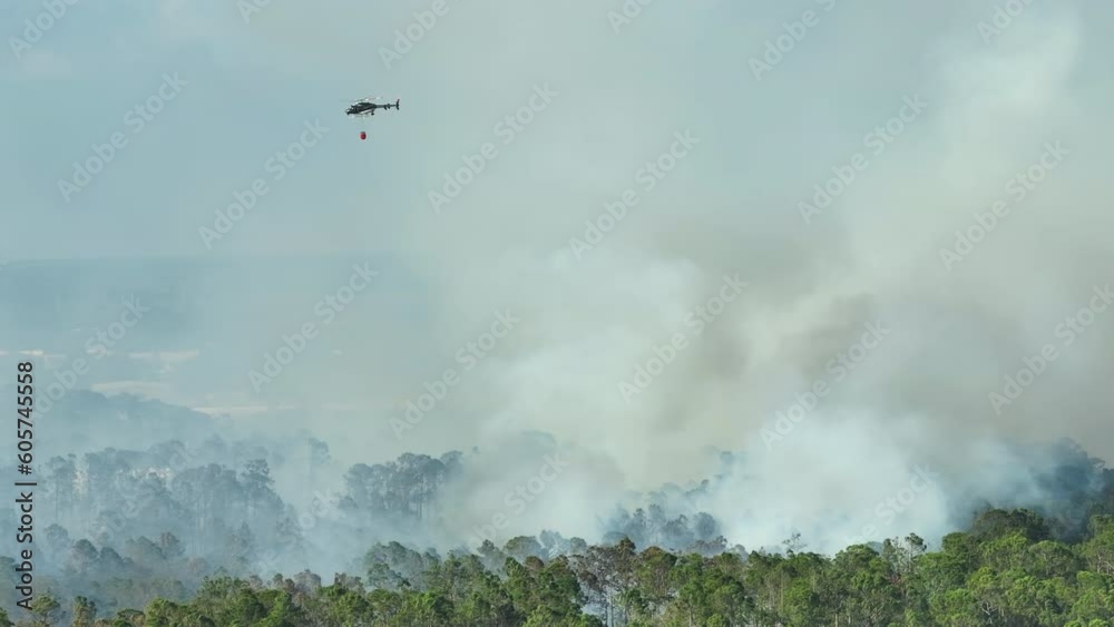 Fire department chopper extinguishing wildfire burning severely in ...