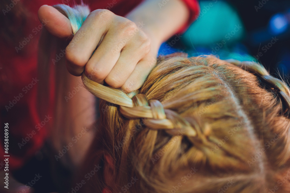 Process of braiding the master weaves braids on her head blond little ...