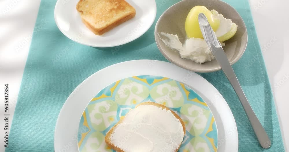 spreading cream cheese on toast. making a sandwich. Balkan cheese ...