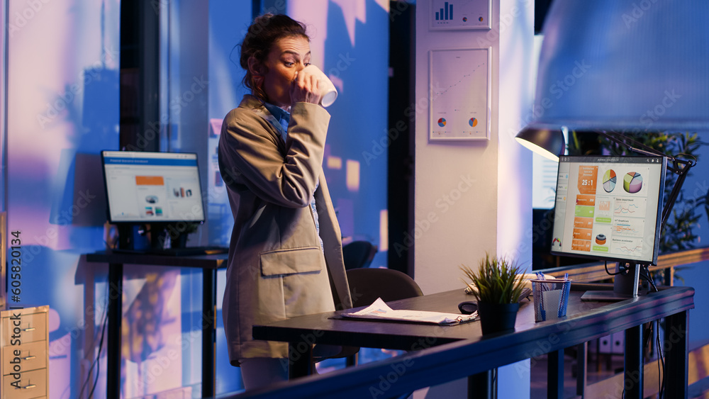 Exhausted manager working overtime on research plan, yawning while ...