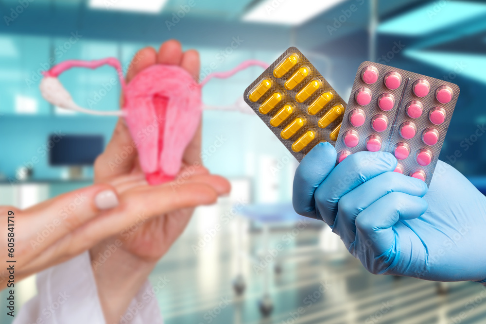 Medicines for women. Tablets in hands of doctor. Uterus and ovaries ...