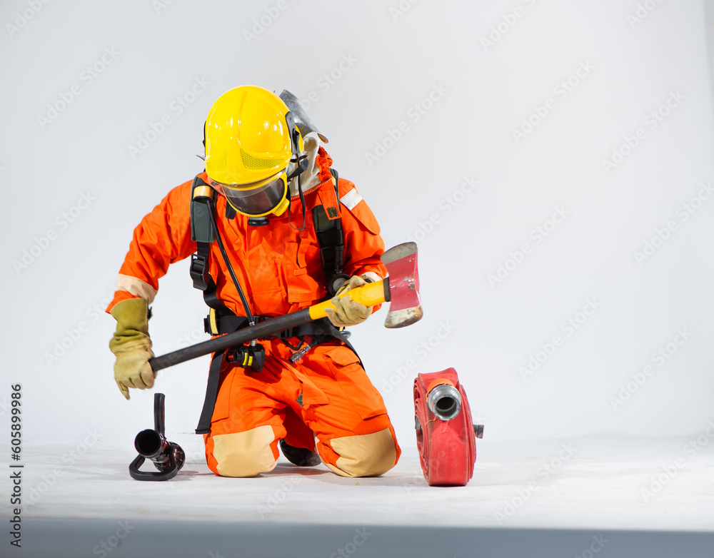 Professional firefighter is sitting looking down and kneeling down ...