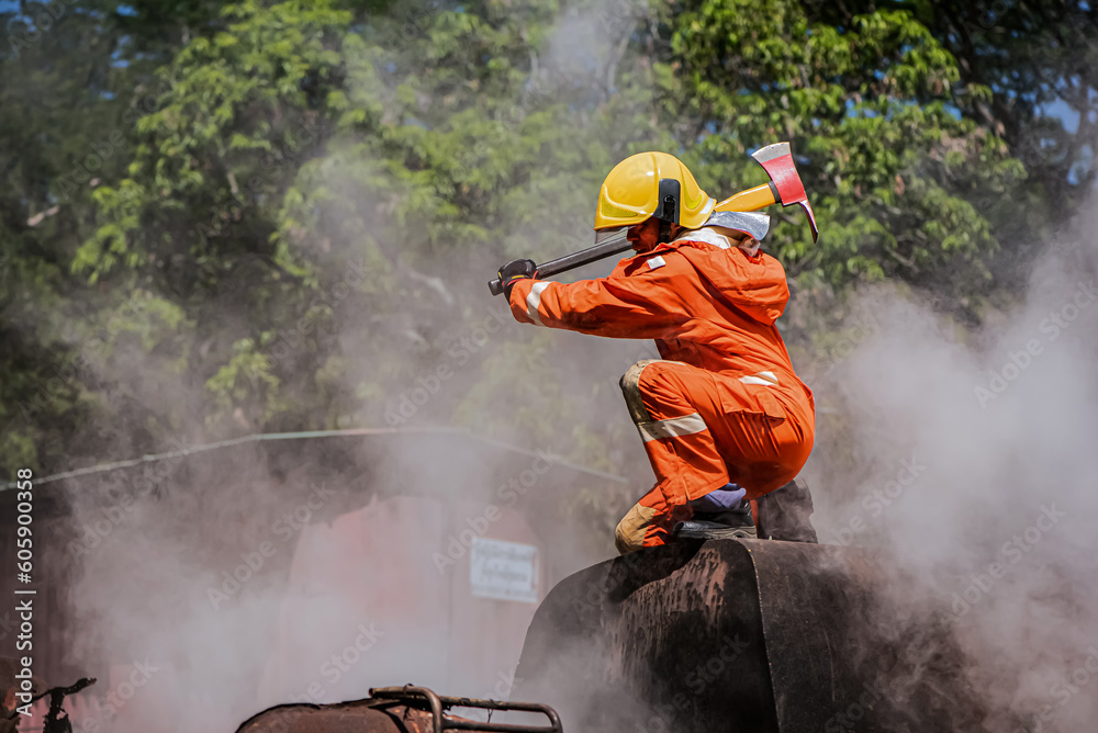 Foto de Professional firefighter is sitting and kneeling down on a ...