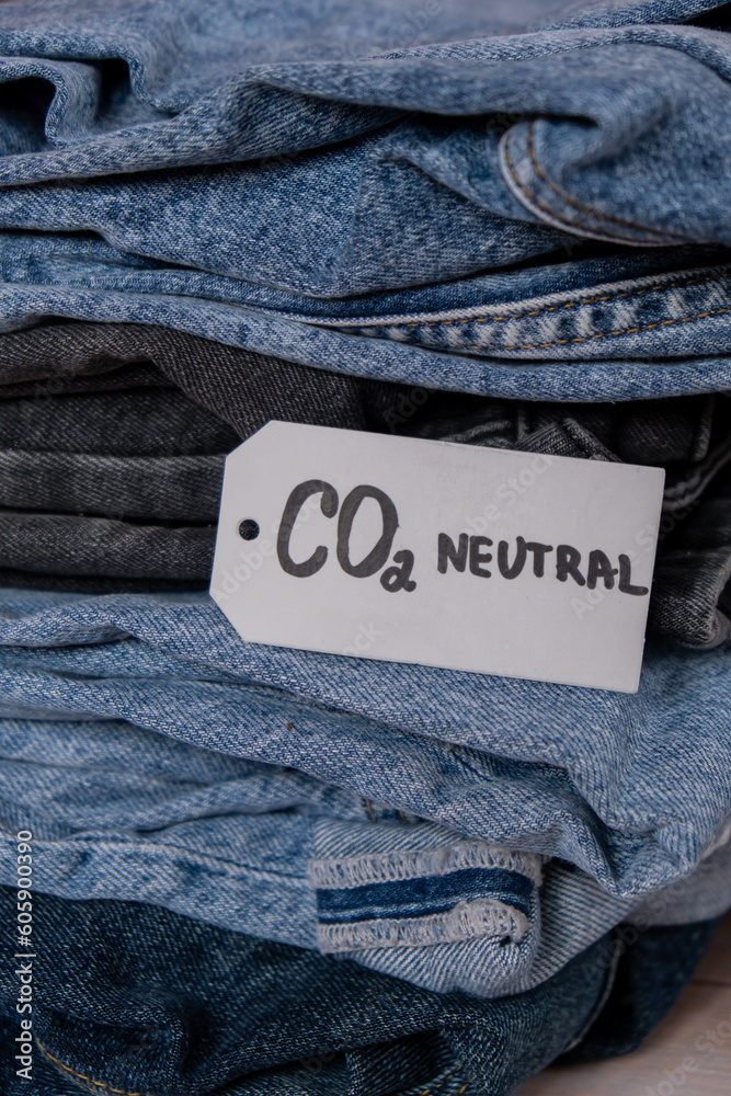 CO2 neutral emission text note on stack of jeans. Ecology nature ...