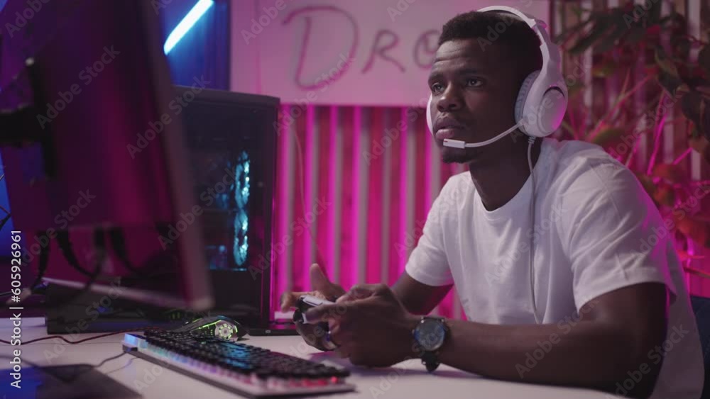 African American Man Playing Video Game On PC With Joystick And Headset ...