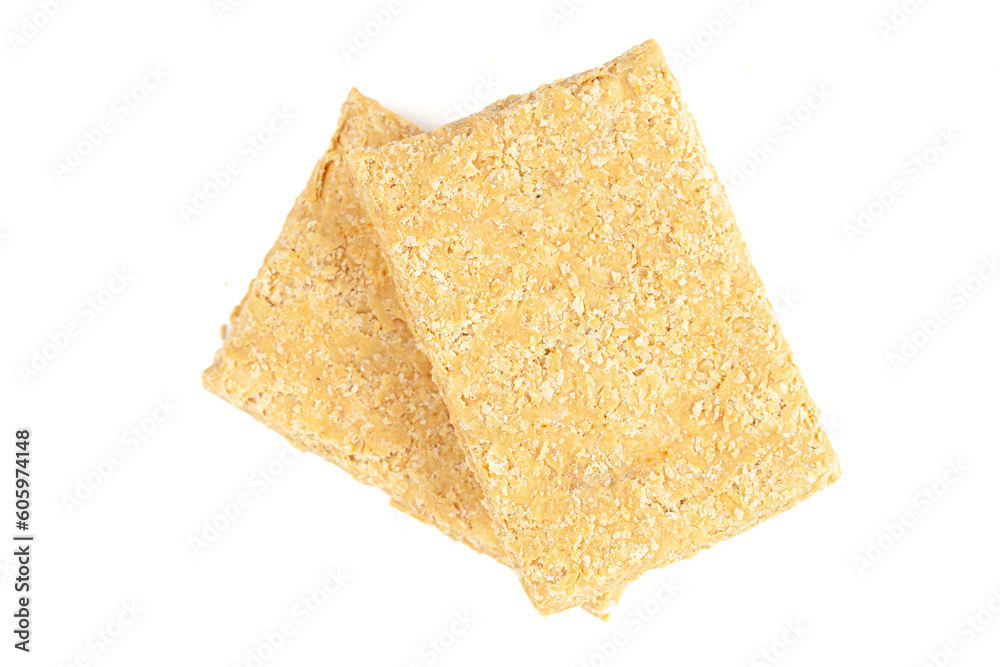 Two pieces of Indian mithai (dessert), delicate, soft, crunchy Gajak ...