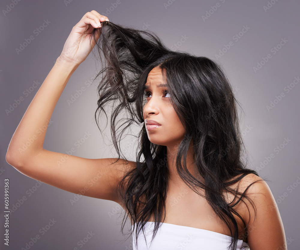 Frustrated, hair damage and woman with split ends on studio background ...
