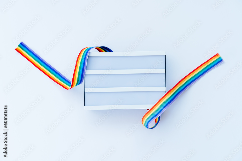Top view White light box mockup with rainbow LGBT ribbon on a light ...