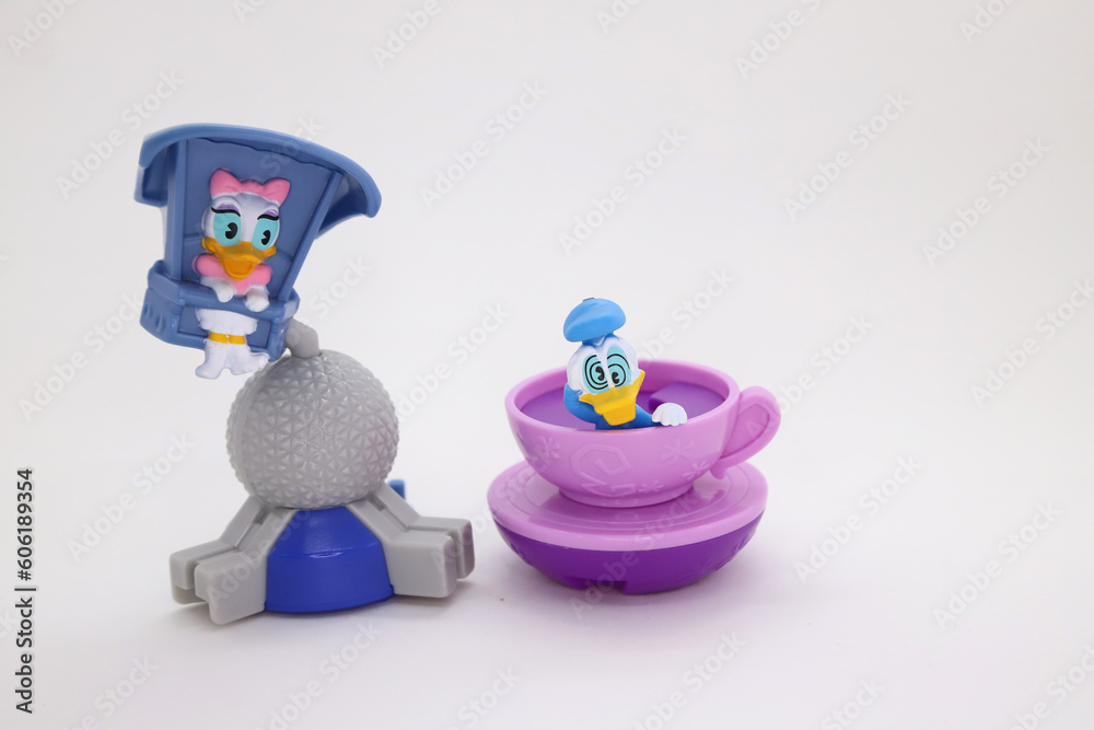 Daisy Duck in a flying game and dizzy Donald Duck in rotating cup at ...