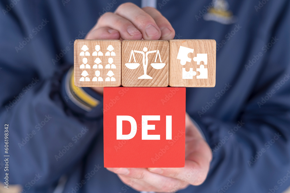 Man holding colorful blocks with abbreviation: DEI. Concept of DEI ...