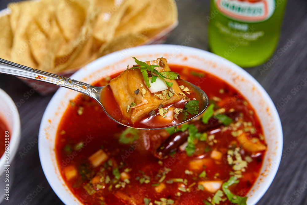 Menudo soup hominy grits tripe stew Mexican meal Jarritos lime soda ...