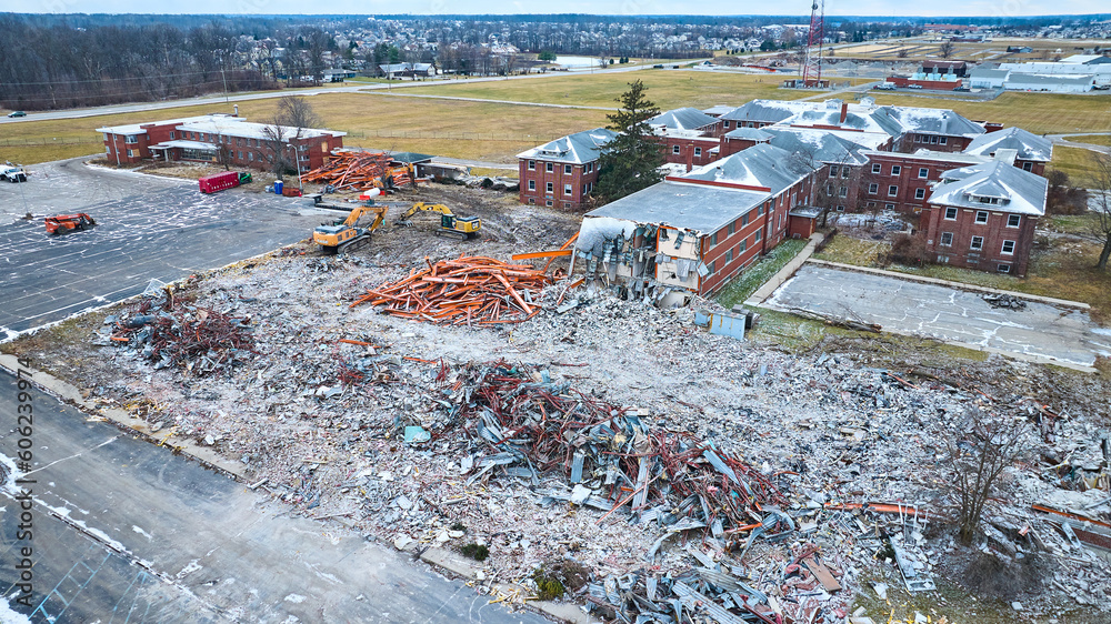 Drone aerial of deconstruction site of old abandoned hospital building ...