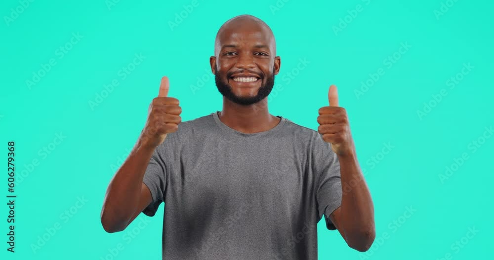 Happy, face and black man with thumbs up in studio isolated on a blue ...