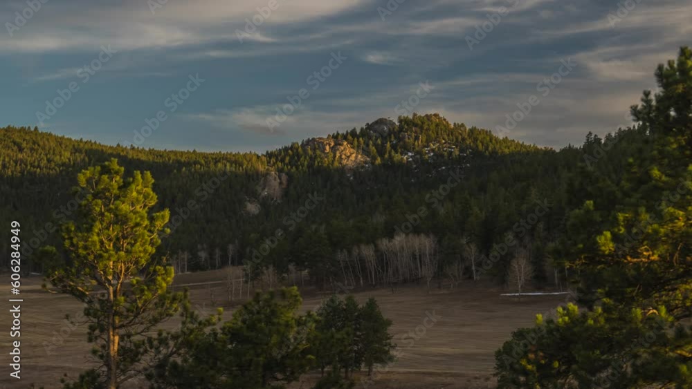 Timelapse Evergreen Conifer Colorado early spring sunrise over meadow ...