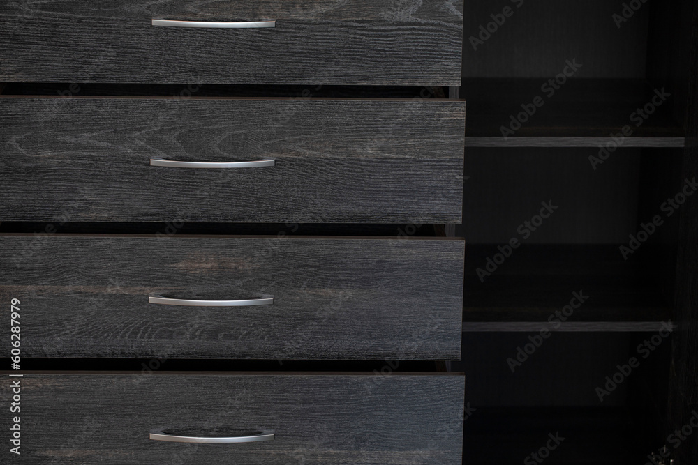 Chest of drawers with extended empty drawers and shelves in black and ...