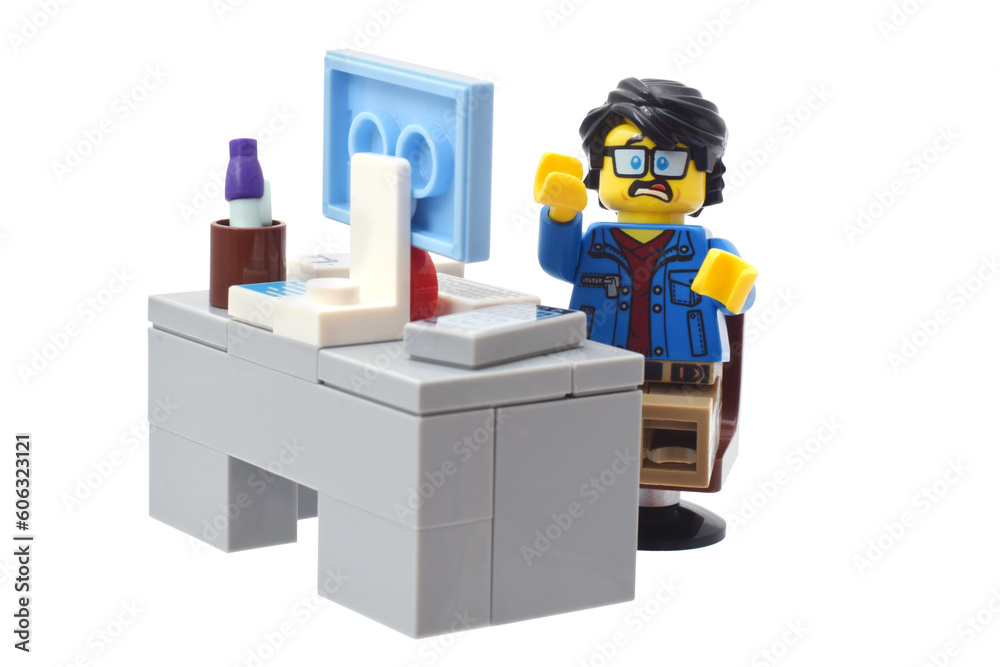 Lego minifigure toy of awful pc user with angry face at slow computer ...
