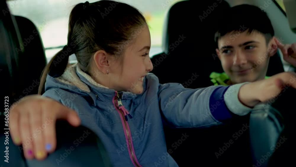 Portrait happy girl with boy traveling by car. Sister and brother on ...