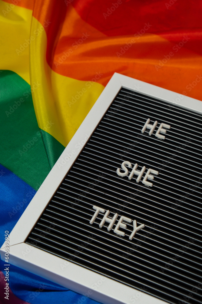 HE SHE THEY text Neo pronouns concept on Rainbow flag background gender ...