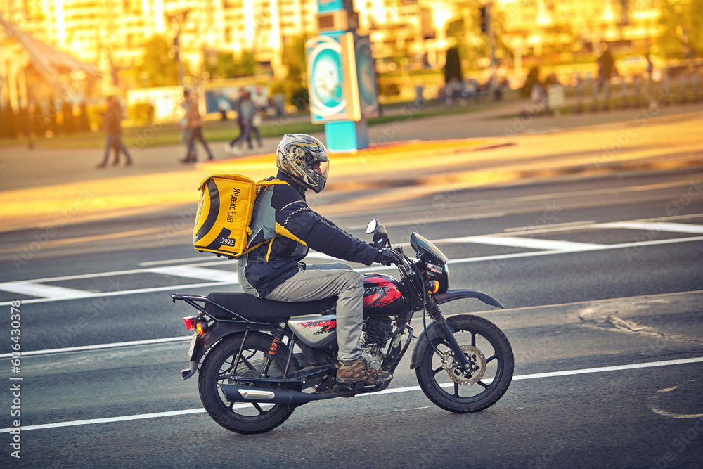 Minsk, Belarus. May 2022. Food delivery man rides motor bike BAJAJ ...