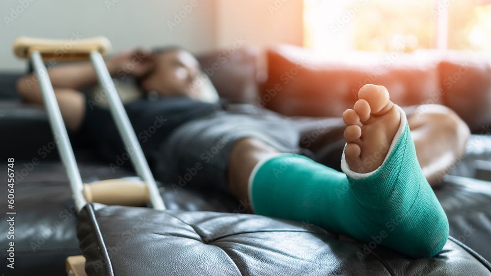 Bone fracture foot and leg on male patient with splint cast and ...
