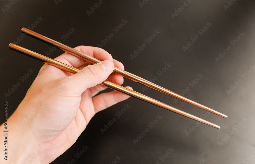 metal utensils - spoon, fork, and chopsticks - representing culinary ...