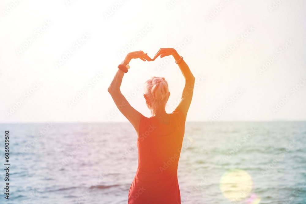 Zdjęcie Stock: Romantic woman embraces herself, making heart shape hand ...