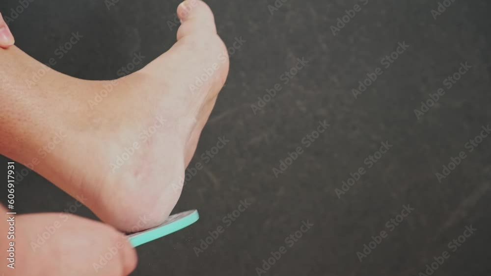 A metallic foot file for pedicure. One side is rough. It is designed to ...