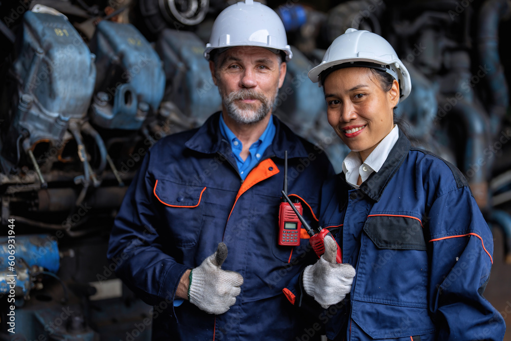 Workers and supervisor congratulations and hand check in heavy engine ...