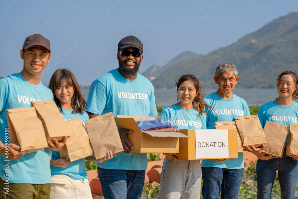 group of diverse volunteer carrying donation box raising money ...