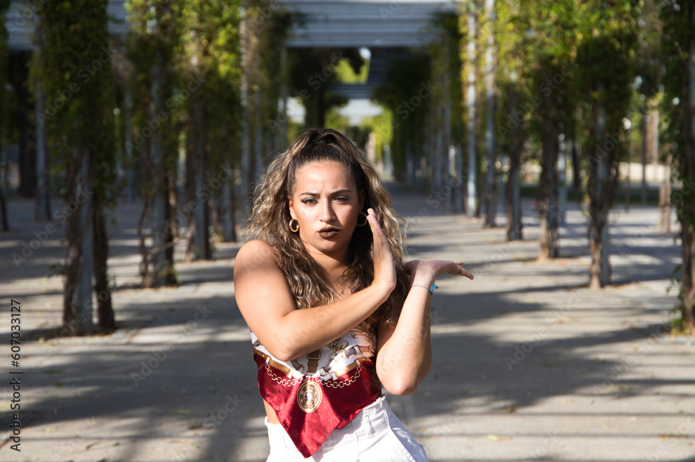Latin woman, young and beautiful dancing modern dance in the street in ...