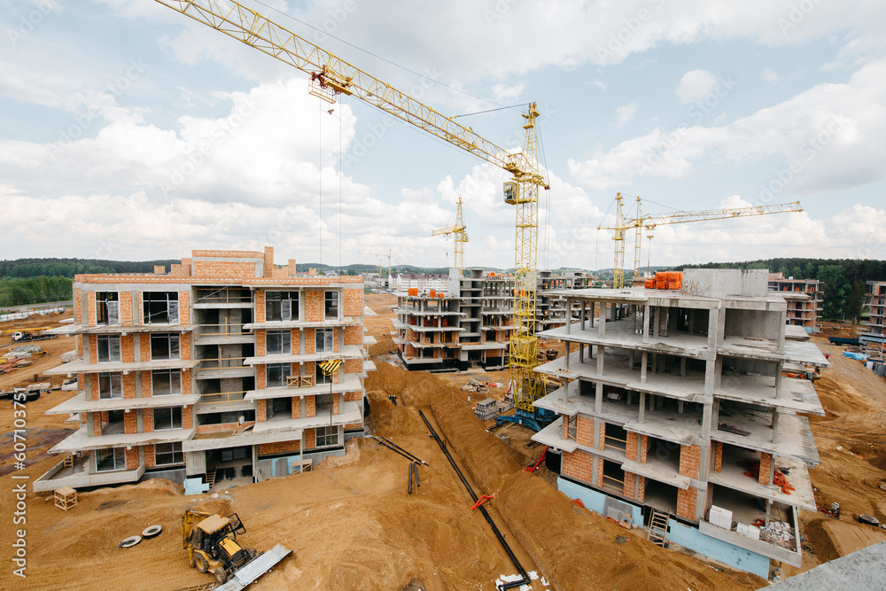 New construction site with cranes on blue sky with clouds background ...