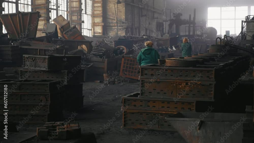 Women backview leaving metalurgical factory for lunch break wearing ...