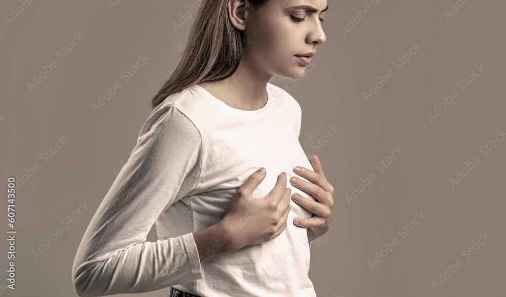 Girl feeling heart pain and holding her chest. Healthcare and medical ...