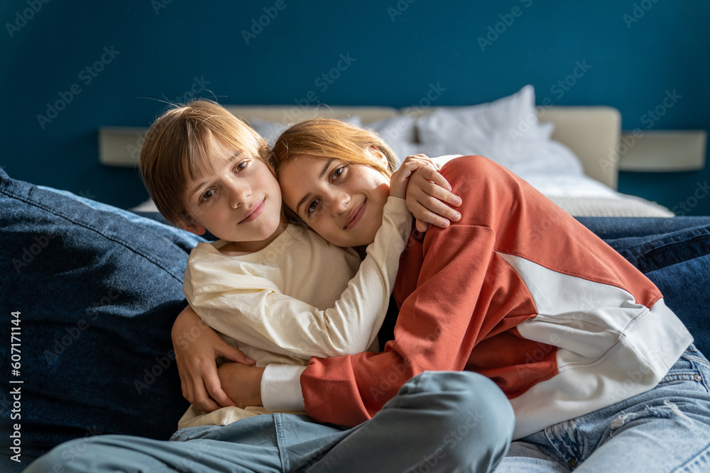 Happy European siblings hugging cuddling feeling love and connection ...