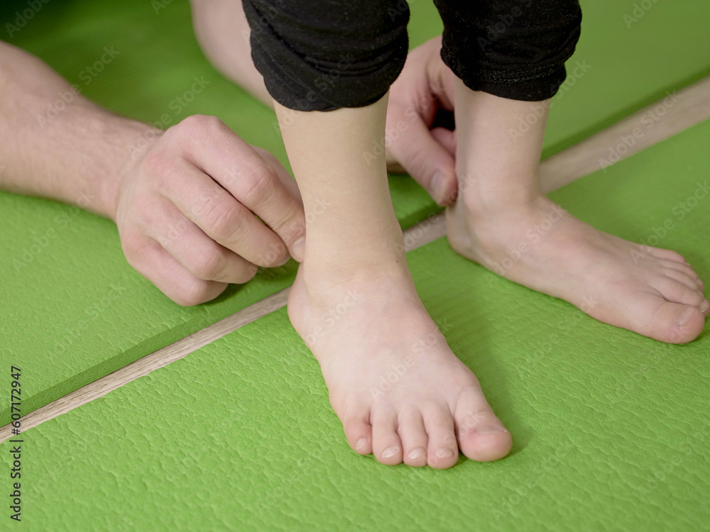 specialist osteopath physiotherapist checks kid leg joints for ligament ...