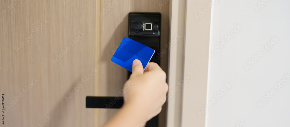 Hand using keycard for smart digital door lock while open or close the ...