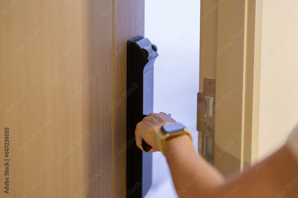 Hand using smart digital door lock while open or close the door at home ...