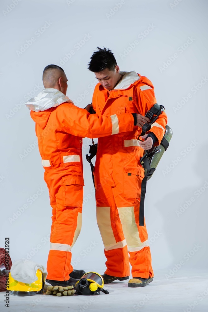 Professional firefighter graciously aids his partner in seamlessly ...