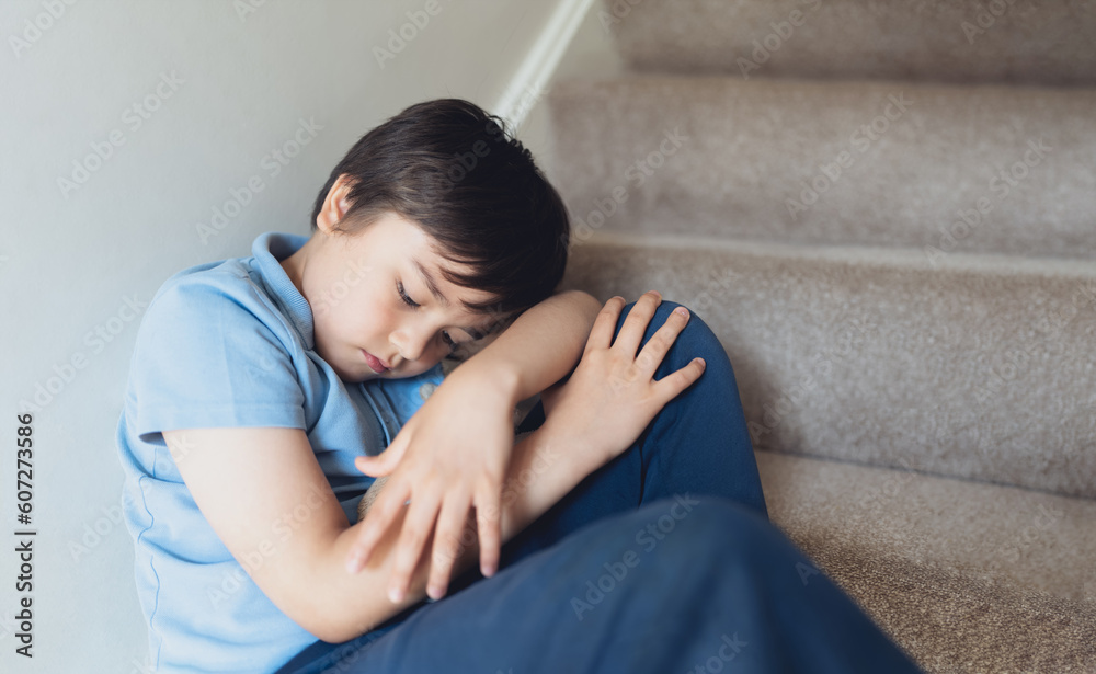 Sad School kid sitting alone on staircase in the morning, Lonely boy ...