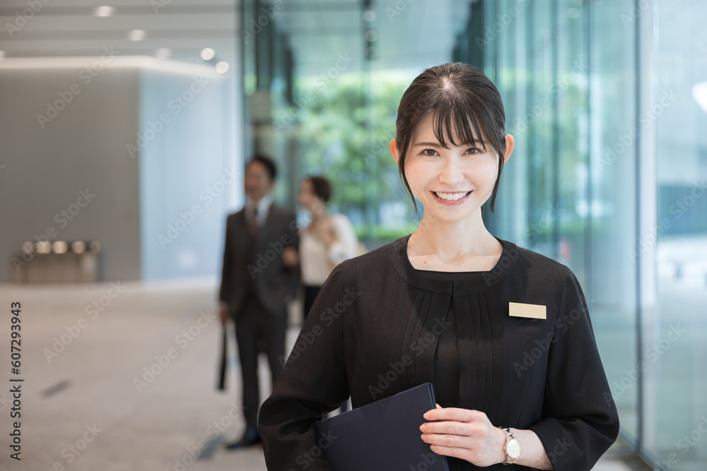 Image of a woman giving directions at a reception desk, concierge ...