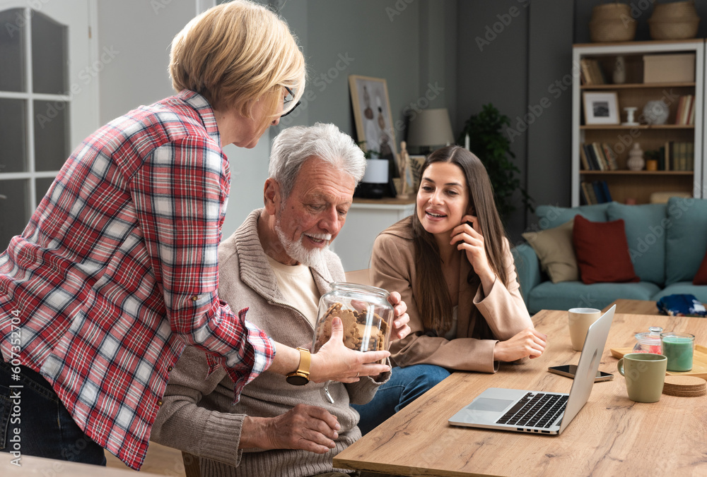 Happy three-generation family hugging sit indoors enjoy time together ...