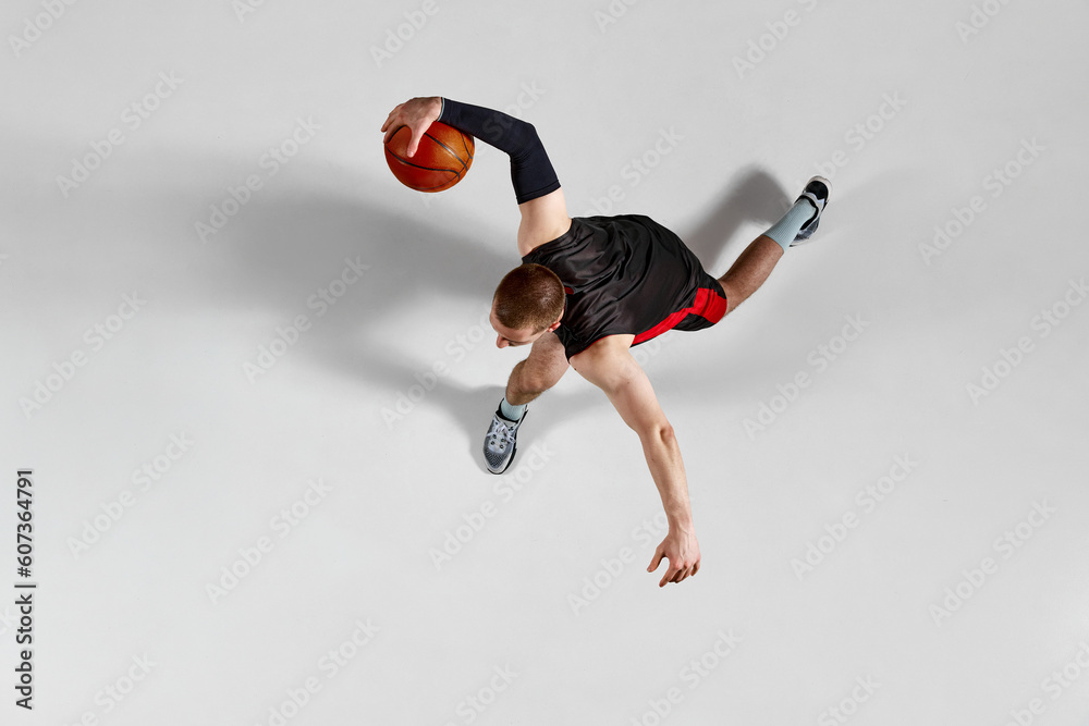 Dynamic image of professional sportsman, basketball player in motion ...