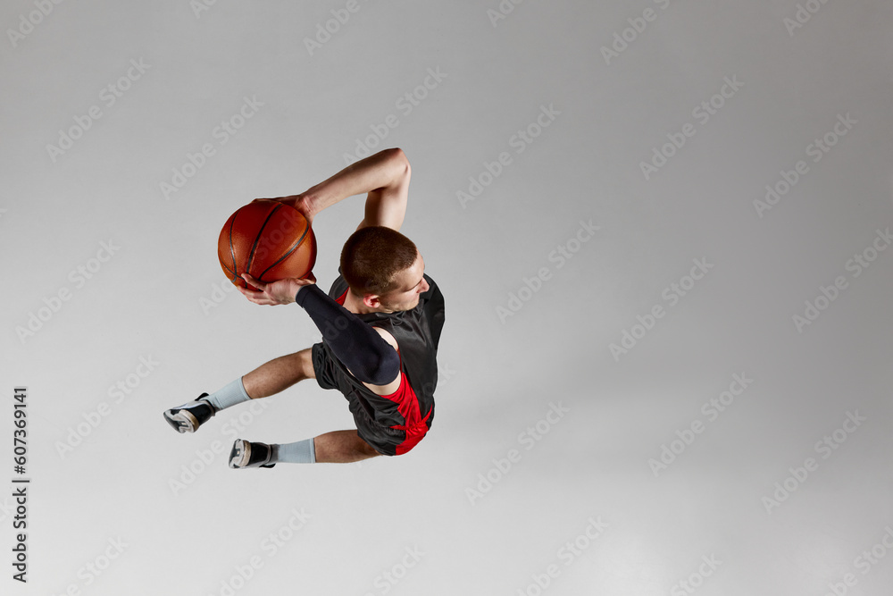 Motivated, concentrated young man, basketball player throwing all in a ...