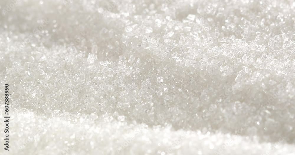 Surface of White Sugar macro. Close up. Slow motion. Hard pieces of ...