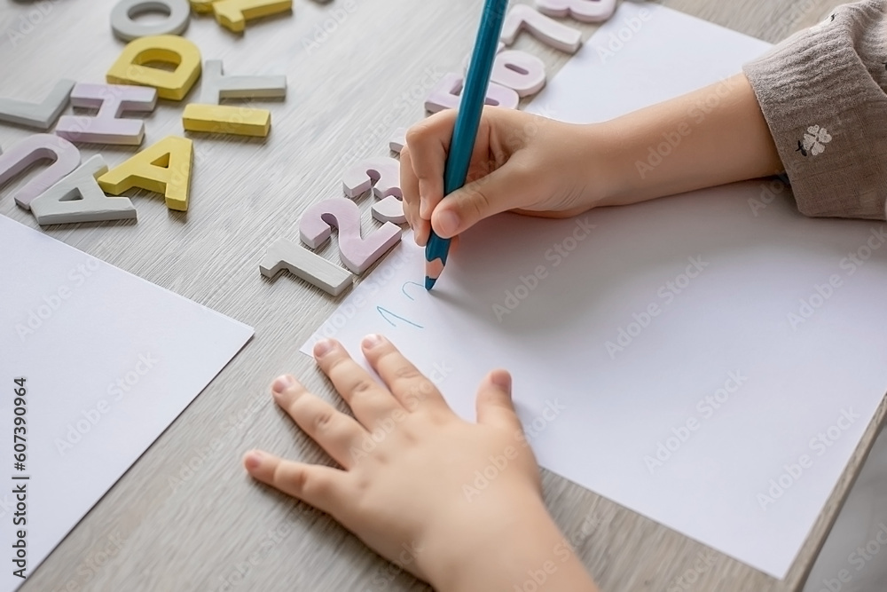 little girl learning numbers. kids learn to write. of child holding ...