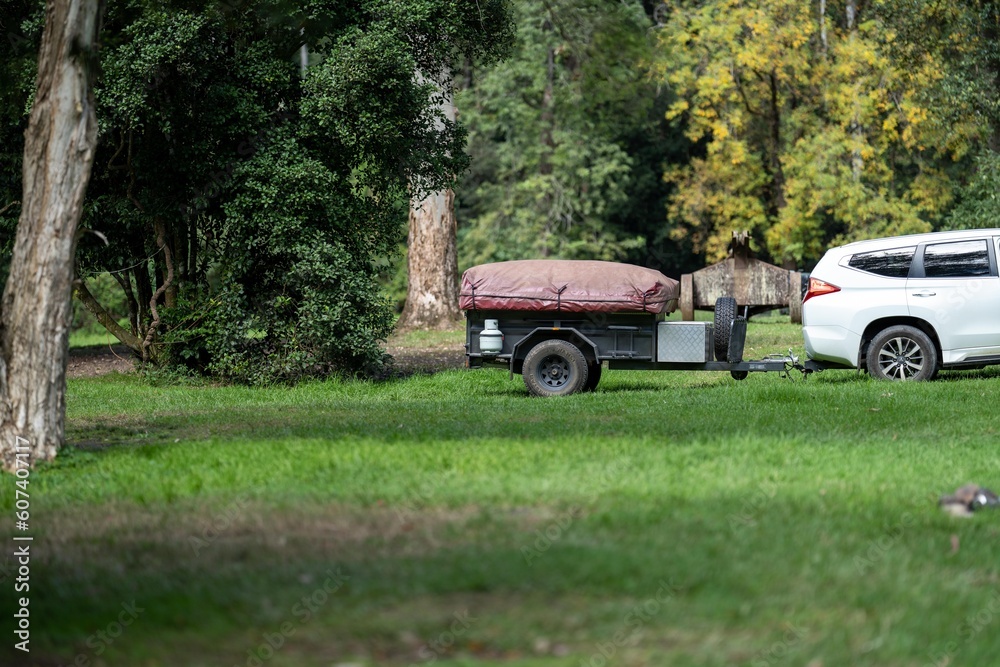 Camper trailer connected to a white car. SUV pulling a camper trailer ...