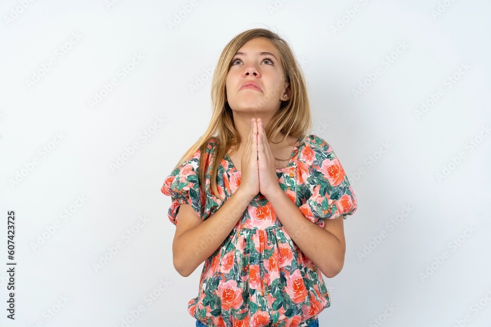 beautiful teen girl wearing flowered dress over white studio background ...